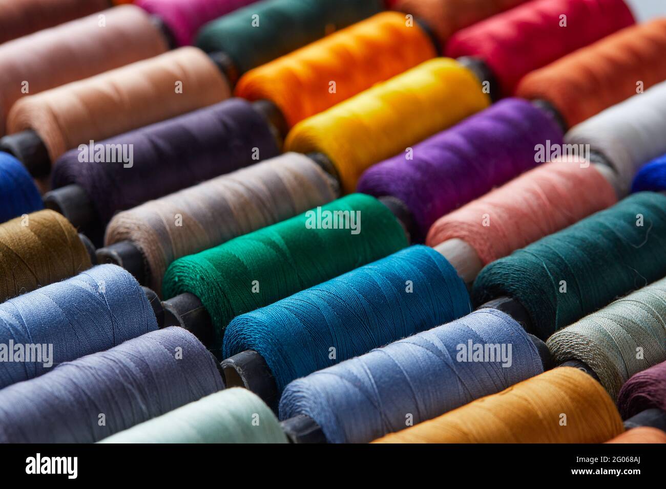 Colorful reels of threads background. Textile factory Stock Photo - Alamy