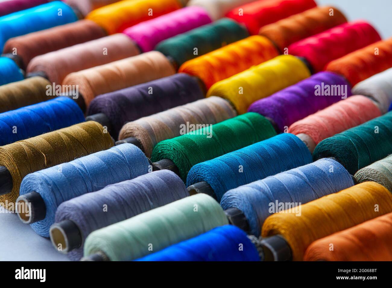 Colorful reels of threads background. Textile factory Stock Photo - Alamy
