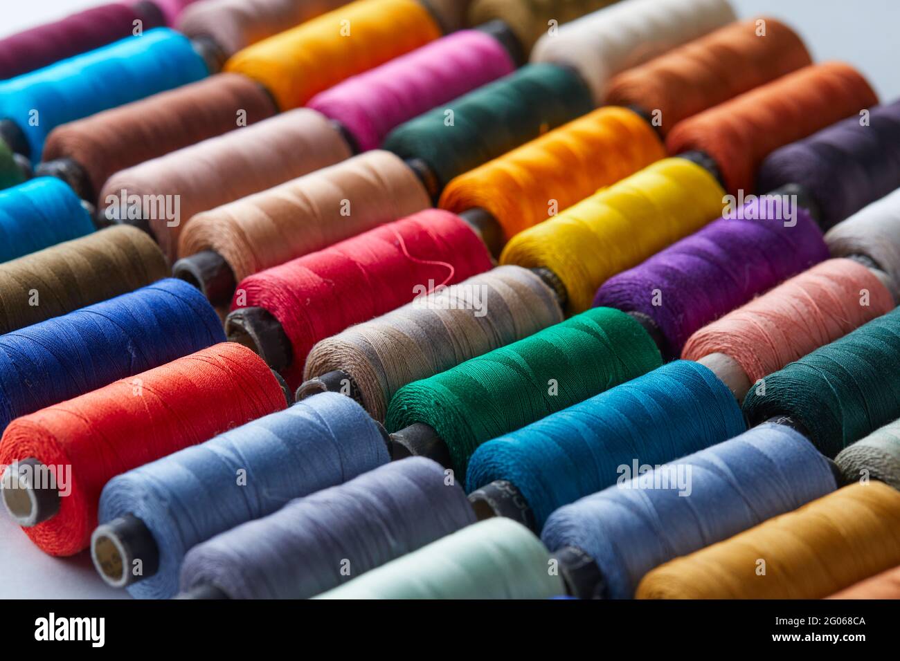 Colorful reels of threads background. Textile factory Stock Photo - Alamy