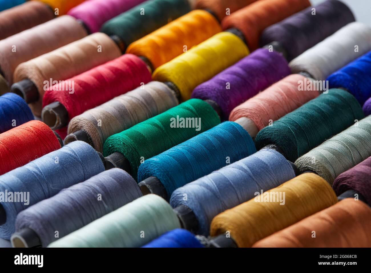 Colorful reels of threads background. Textile factory Stock Photo - Alamy