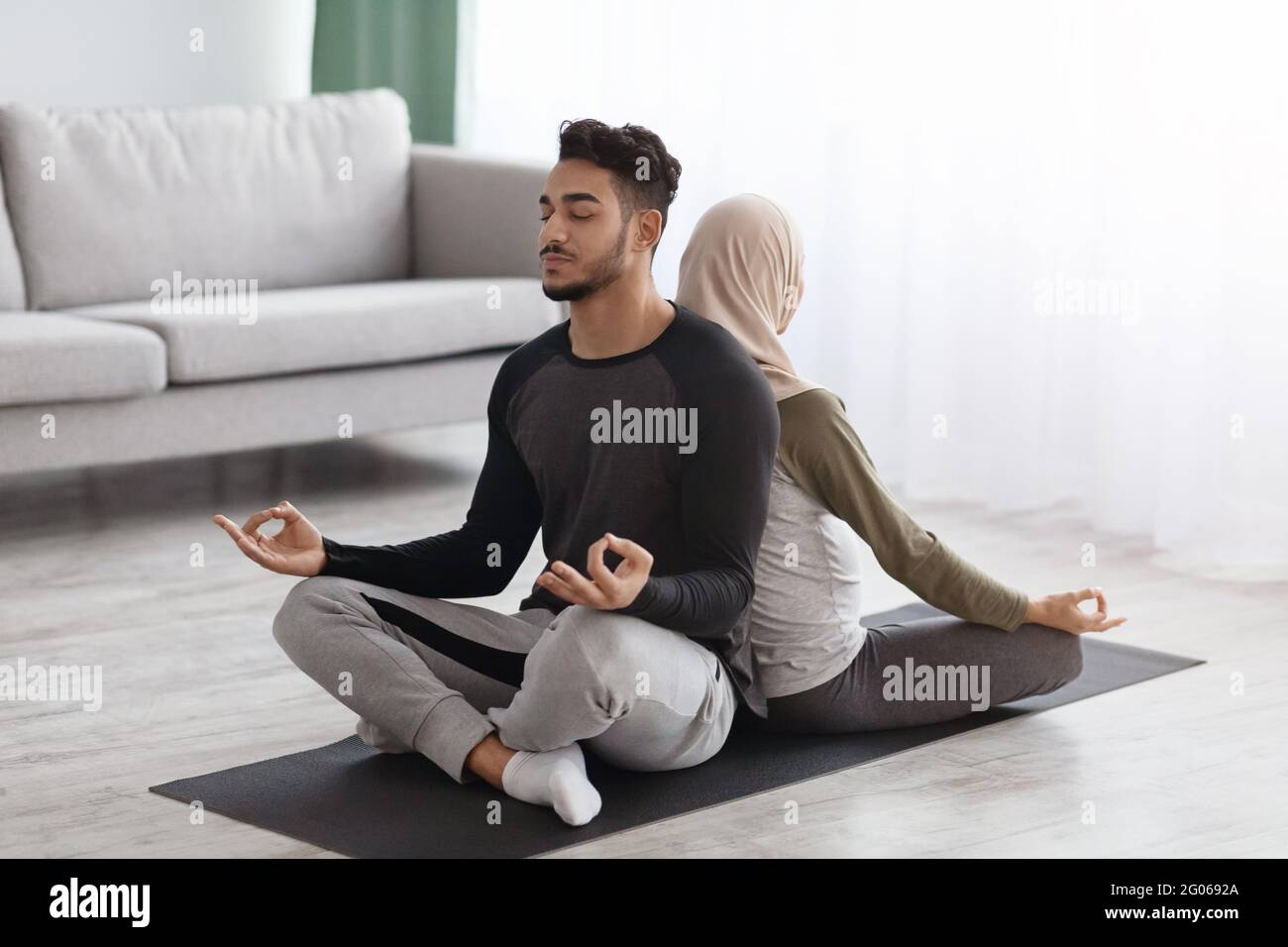 Couple meditating in living hi-res stock photography and images - Alamy