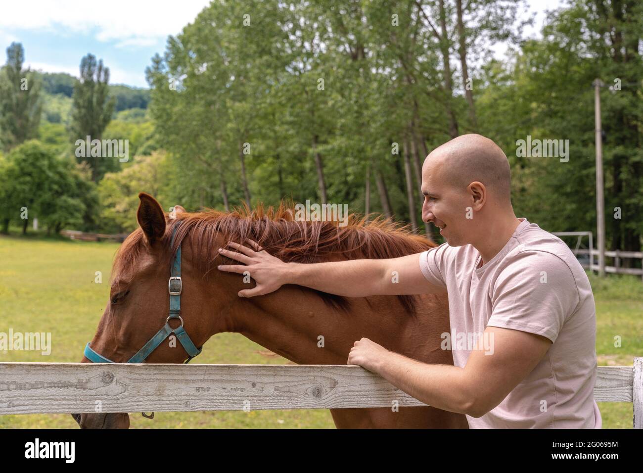 Young adult bonding with a horse at the ranch Stock Photo - Alamy