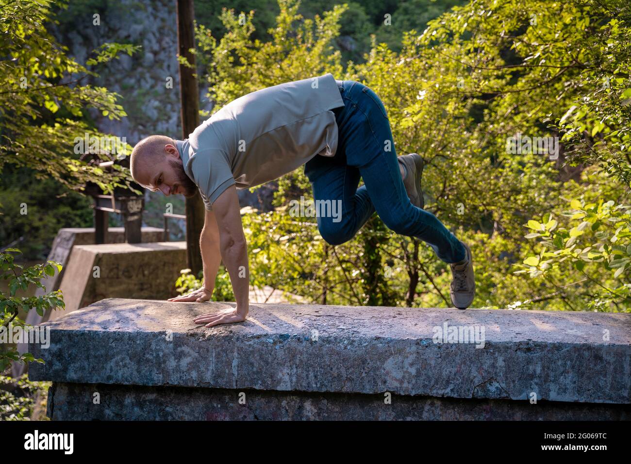 Man jumping over stone wall hi-res stock photography and images - Alamy
