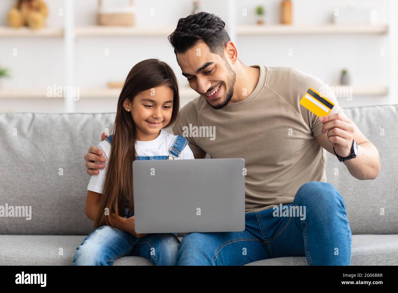 Happy family using computer and credit card at home Stock Photo - Alamy