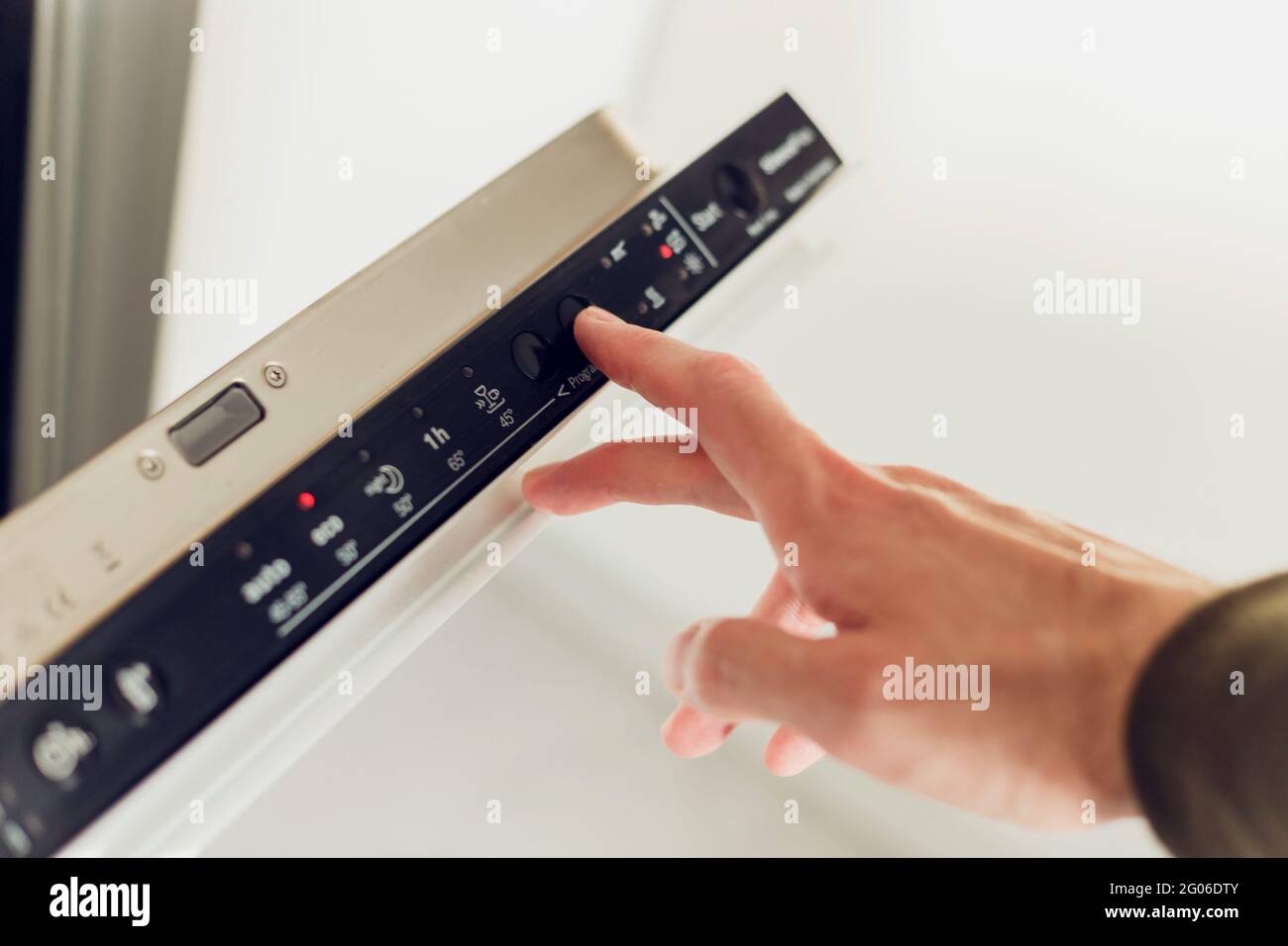 Man choosing mode on the control panel of the dishwasher Stock Photo ...