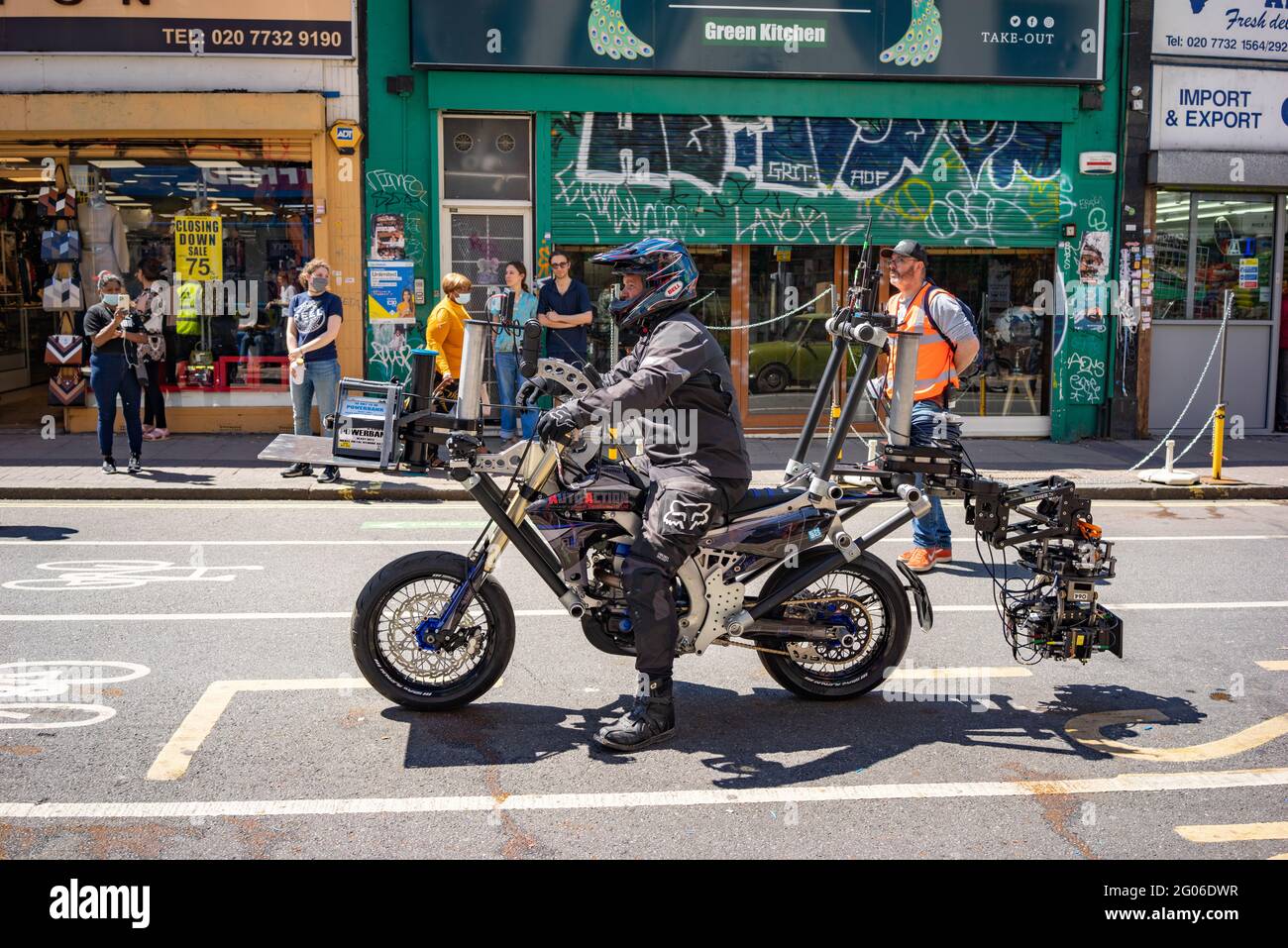 Film crew in Peckham Rye street in south London filming with Director ...