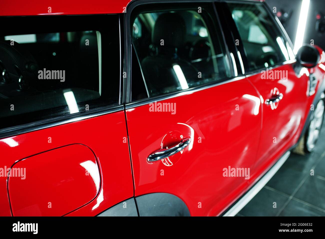 Red polished car in professional detailing garage Stock Photo - Alamy