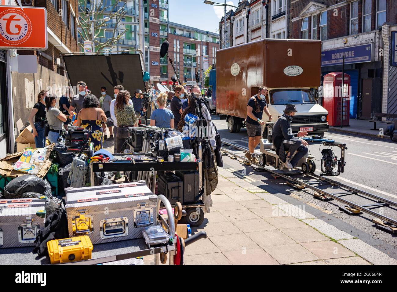 Film crew in Peckham Rye street in south London filming with Director ...