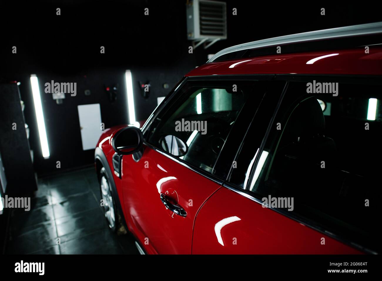 Red polished car in professional detailing garage Stock Photo - Alamy