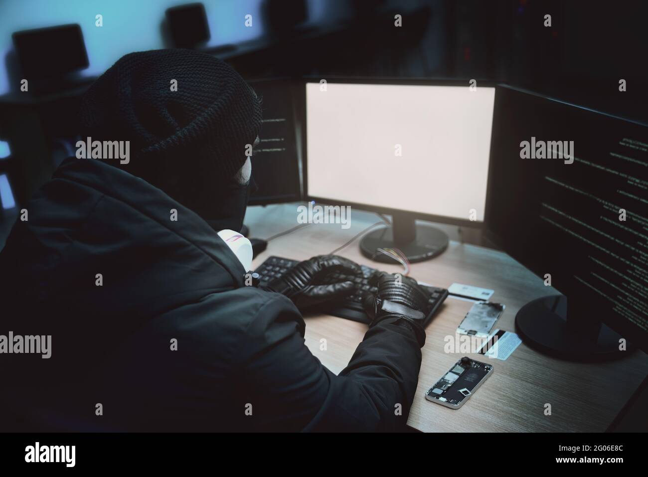Shot from the Back to Hooded Hacker Breaking into Corporate Data Servers from His Underground ...