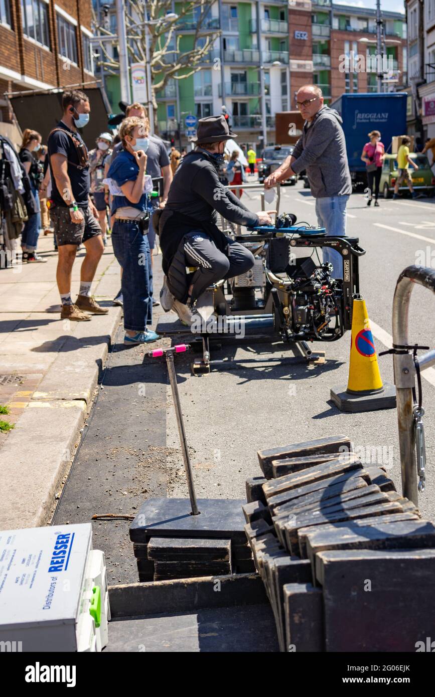 Film crew in Peckham Rye street in south London filming with Director ...