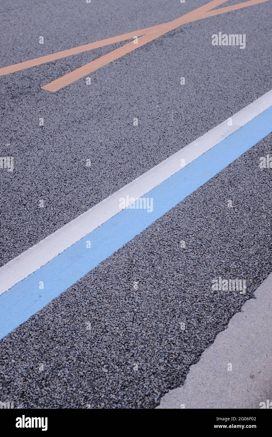 Closeup of blue road markings on the asphalt Stock Photo - Alamy