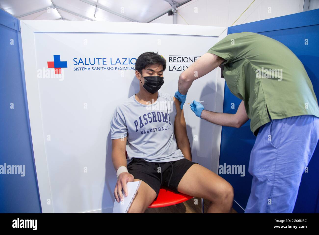 A student undergoes vaccination with Pfizer vaccine inside the ...