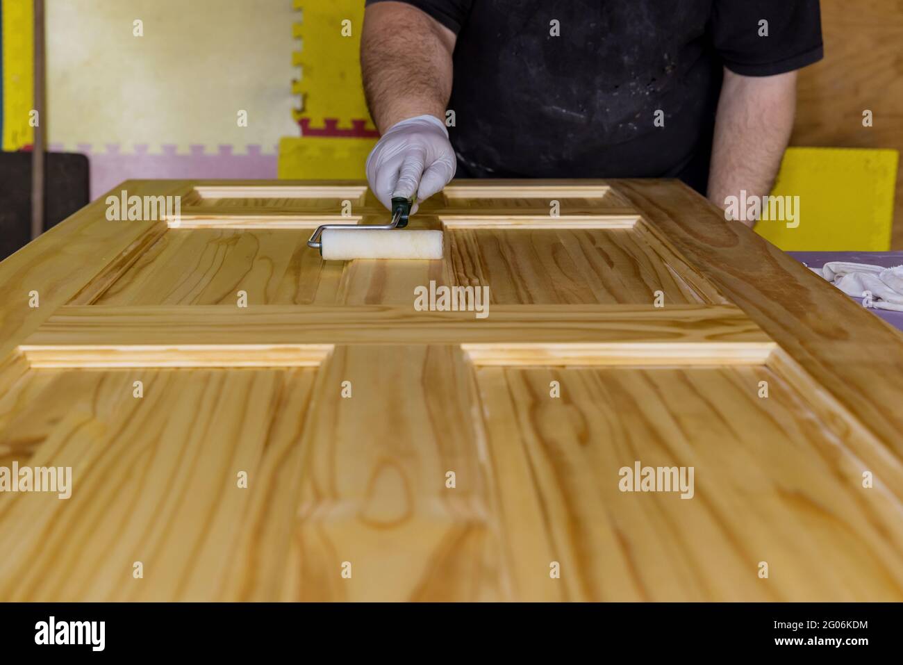 Contractor painter varnish for painting new wooden front door using ...