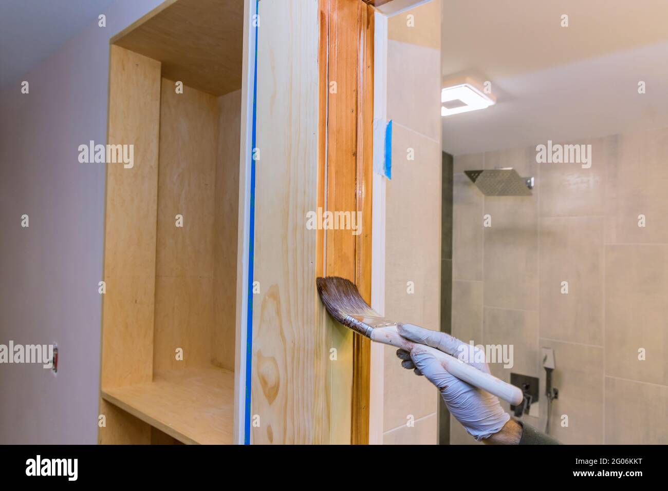 Contractor painter varnish for a brush painting new molding trim wooden ...