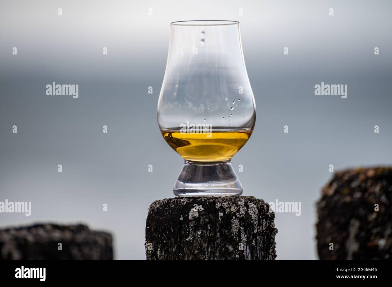 Tasting of dram single malt scotch whisky on seashore in Scotland, old ...