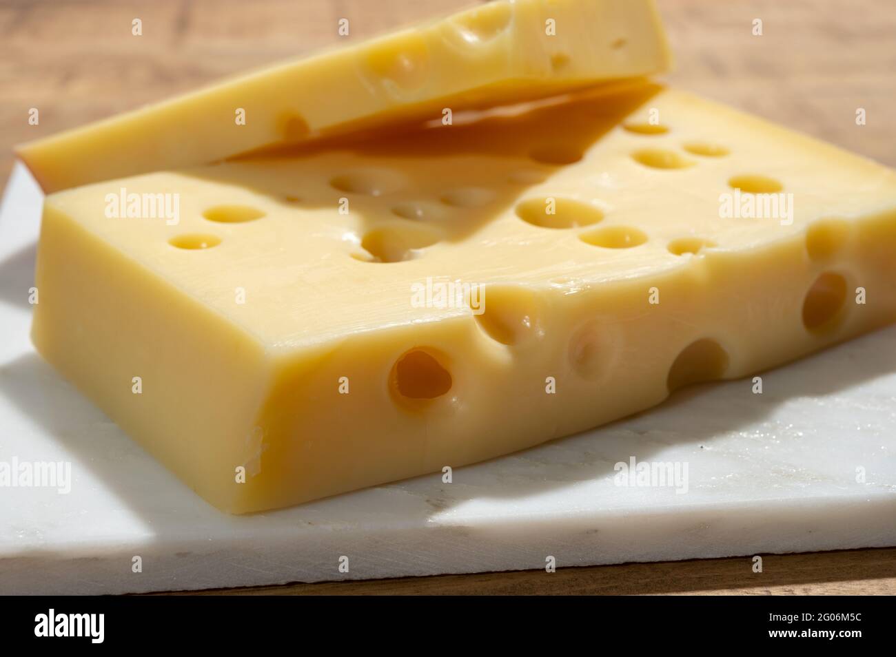 Cheese collection, blocks of French emmentaler cheese with many round ...