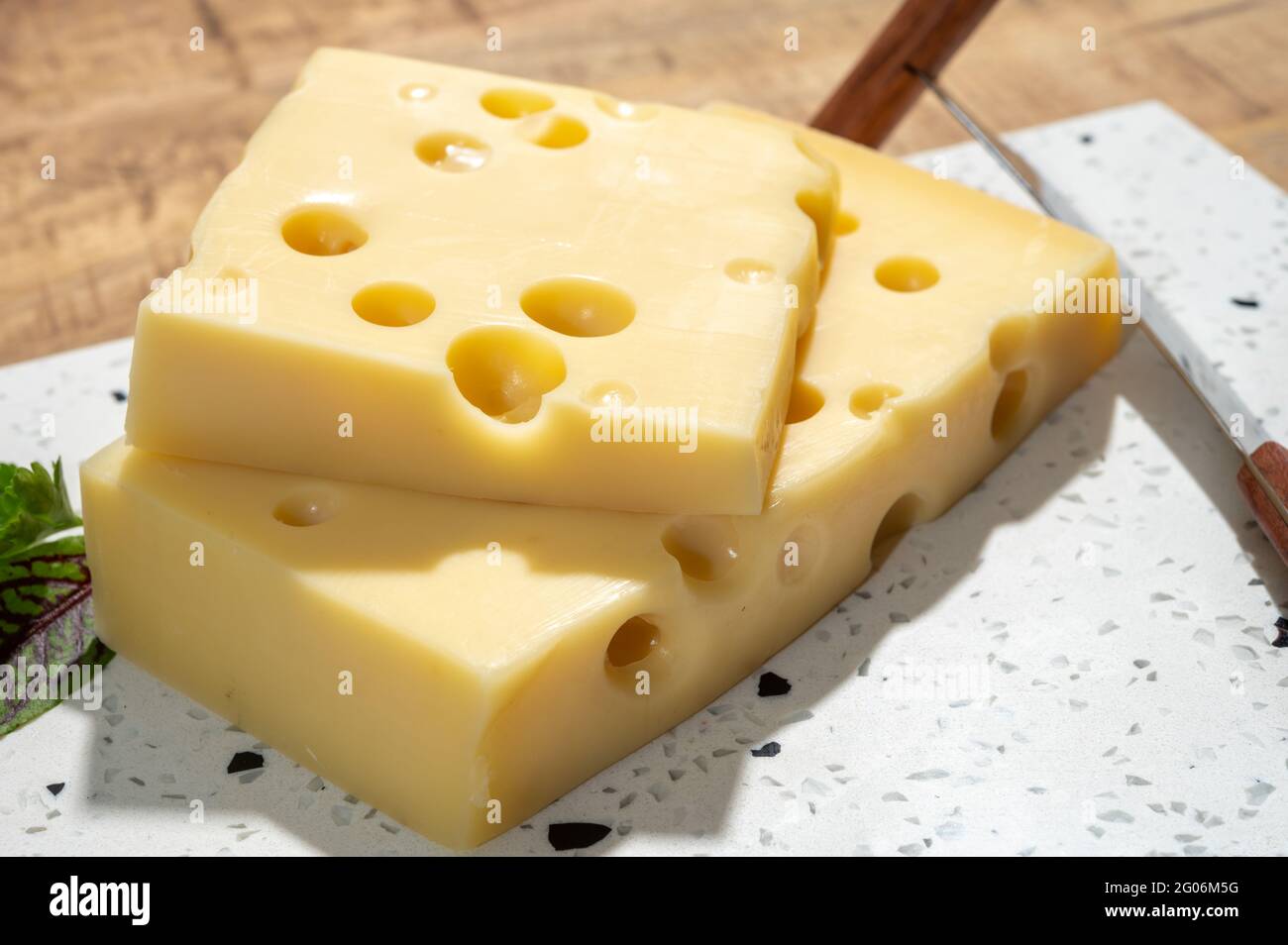 Cheese collection, blocks of French emmentaler cheese with many round ...