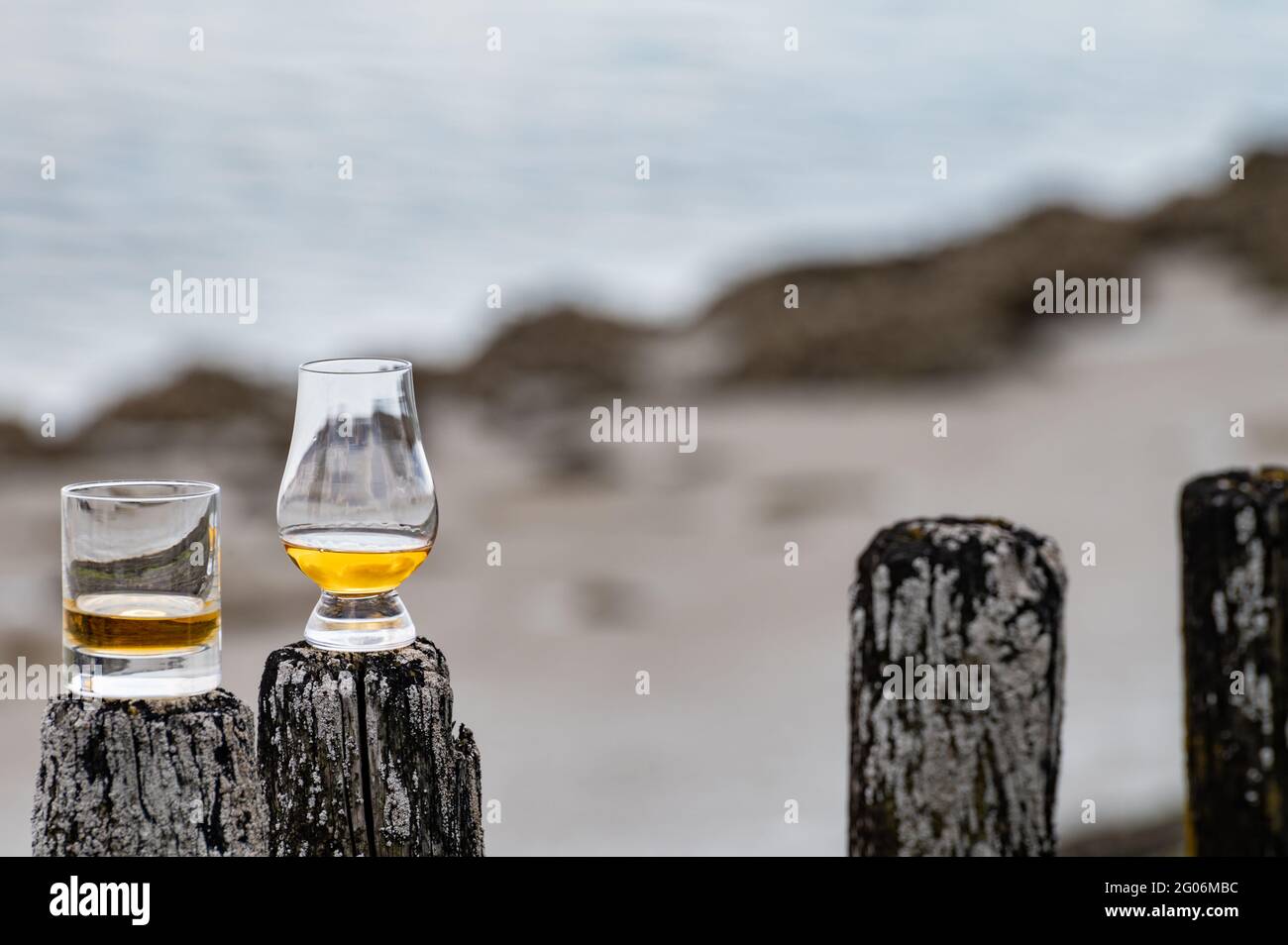 Tasting of dram single malt scotch whisky on seashore in Scotland, old ...
