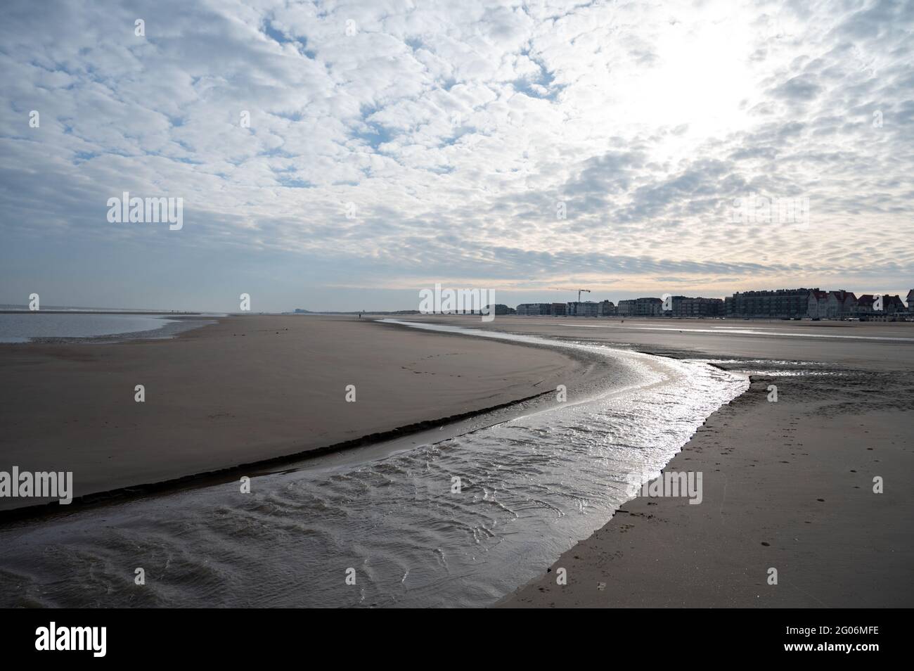 Low ride period on yellow sandy beach in small Belgian town De Haan or ...