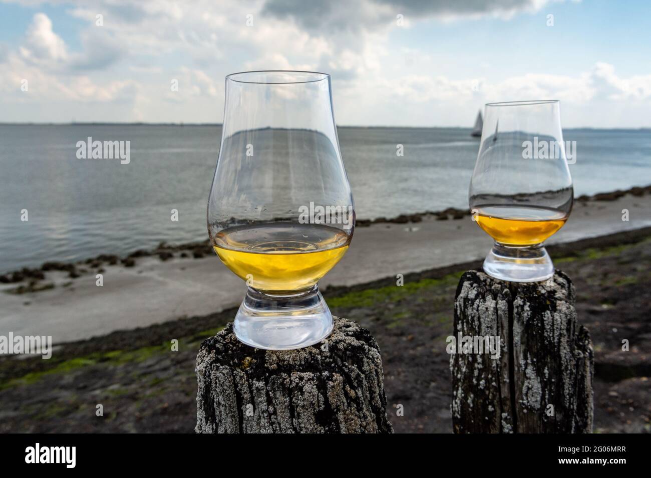 Tasting of dram single malt scotch whisky on seashore in Scotland, old ...