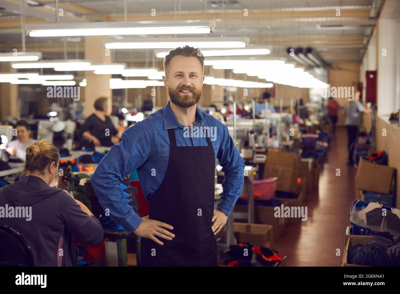 Portrait of a confident smiling factory worker or shoe factory owner at ...