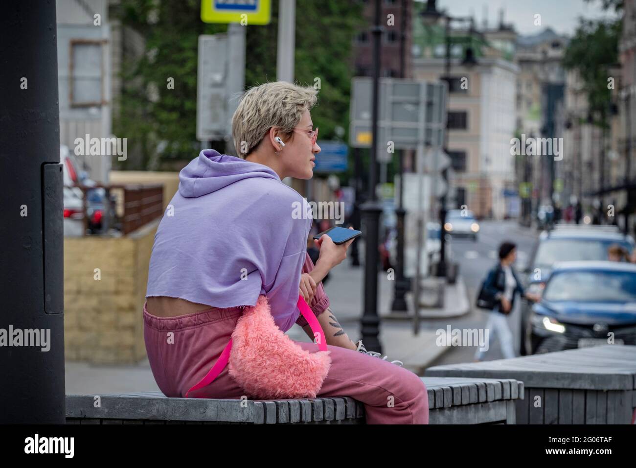 Russia, Moscow. A girl sitting on a bench in a street Stock Photo - Alamy
