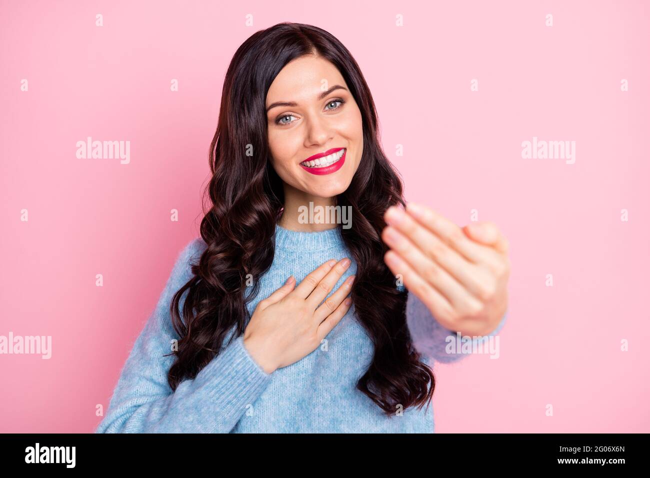 Photo of grateful sincere young girl hold show welcome sign wear blue ...