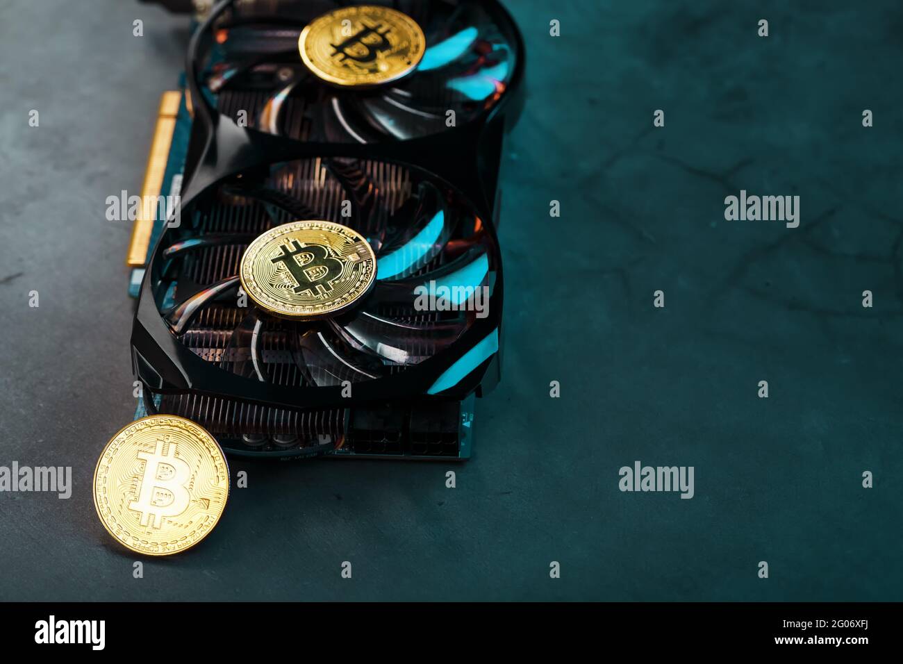 Gold bitcoins on a video card with a blue backlight in the style of ...