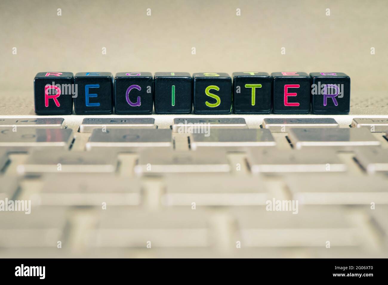 the word is register on the black cubes lying on the gray keyboard. The ...