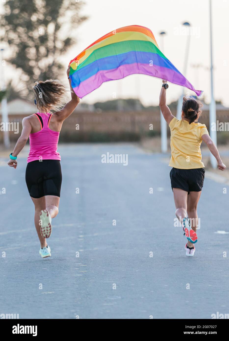 Girls running with LGBT flag. LGBT and lesbian couple concept Stock ...