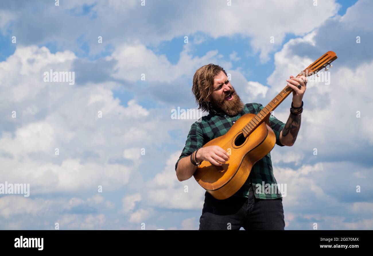 mature bearded man looking casual trendy playing guitar, acoustic music ...
