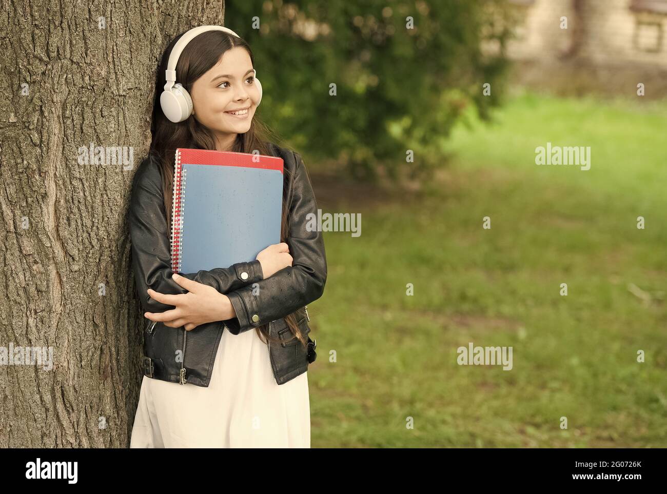 Listening lessons. Happy girl practice listening skills outdoors ...