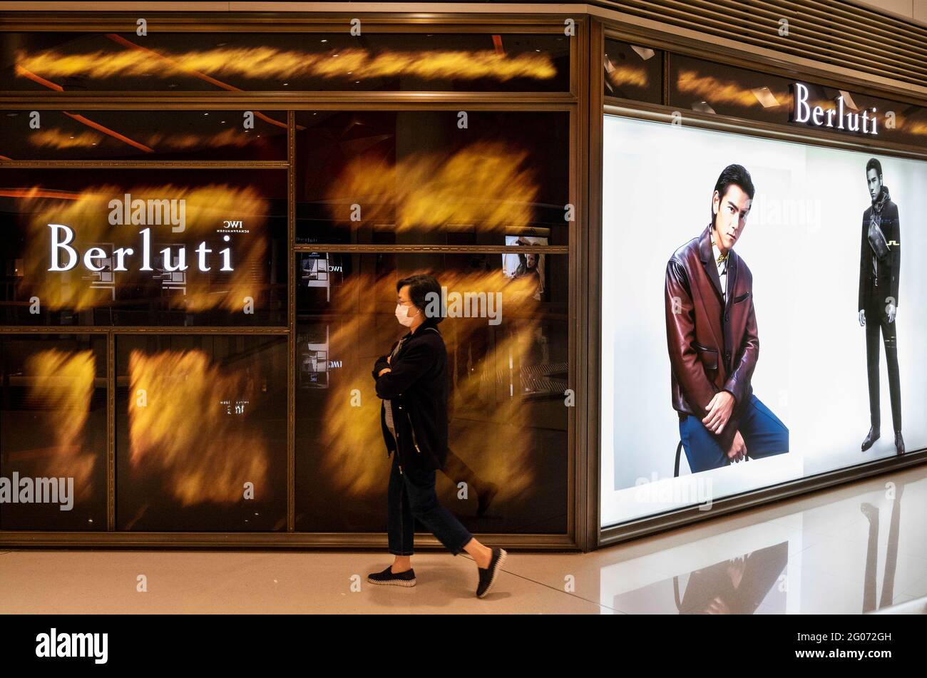 Hong Kong, Hong Kong. 25th Mar, 2021. A shopper walks past the Italian fashion brand Berluti ...