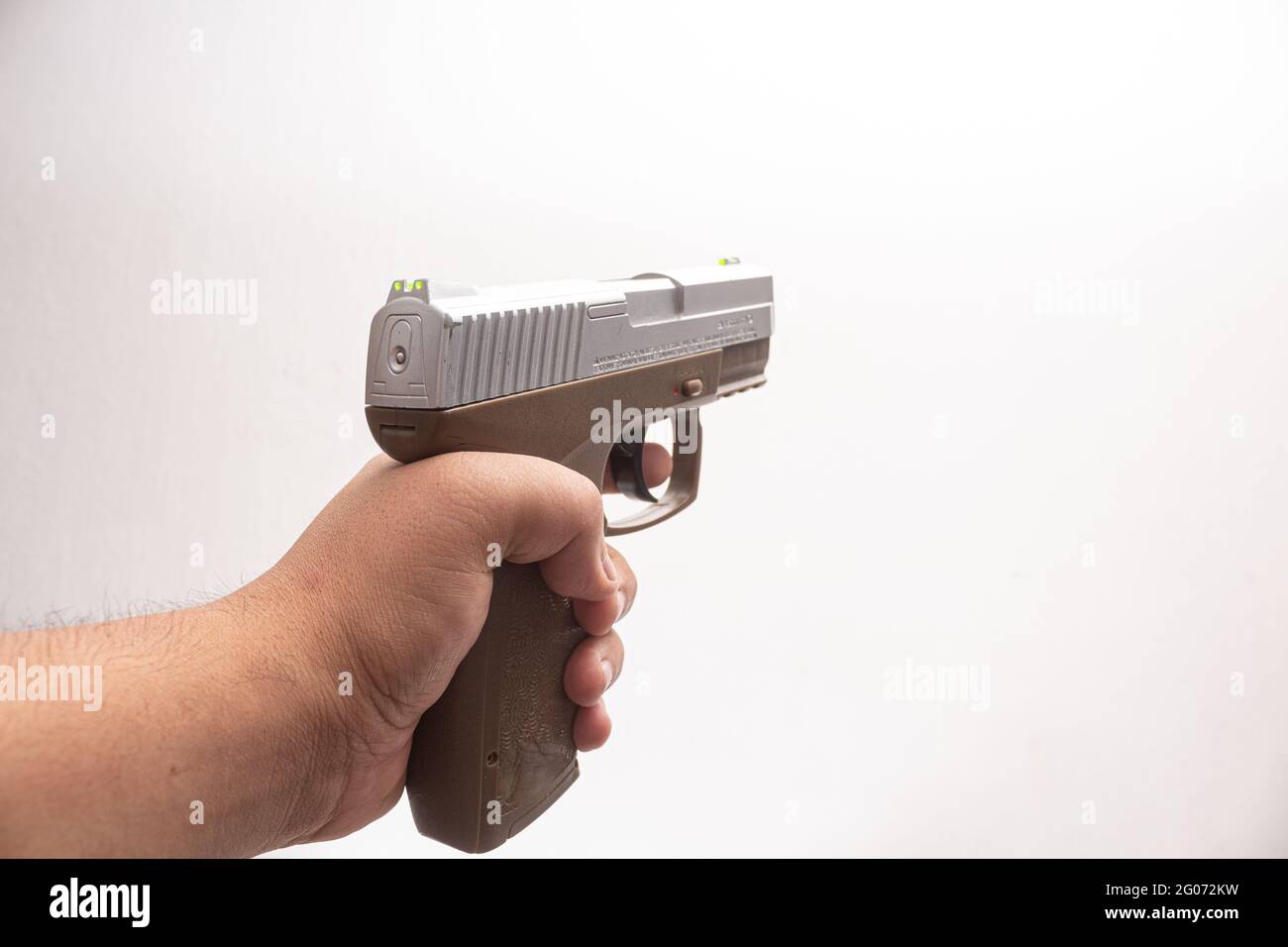 Closeup shot of a pistol on hand isolated on white background Stock ...