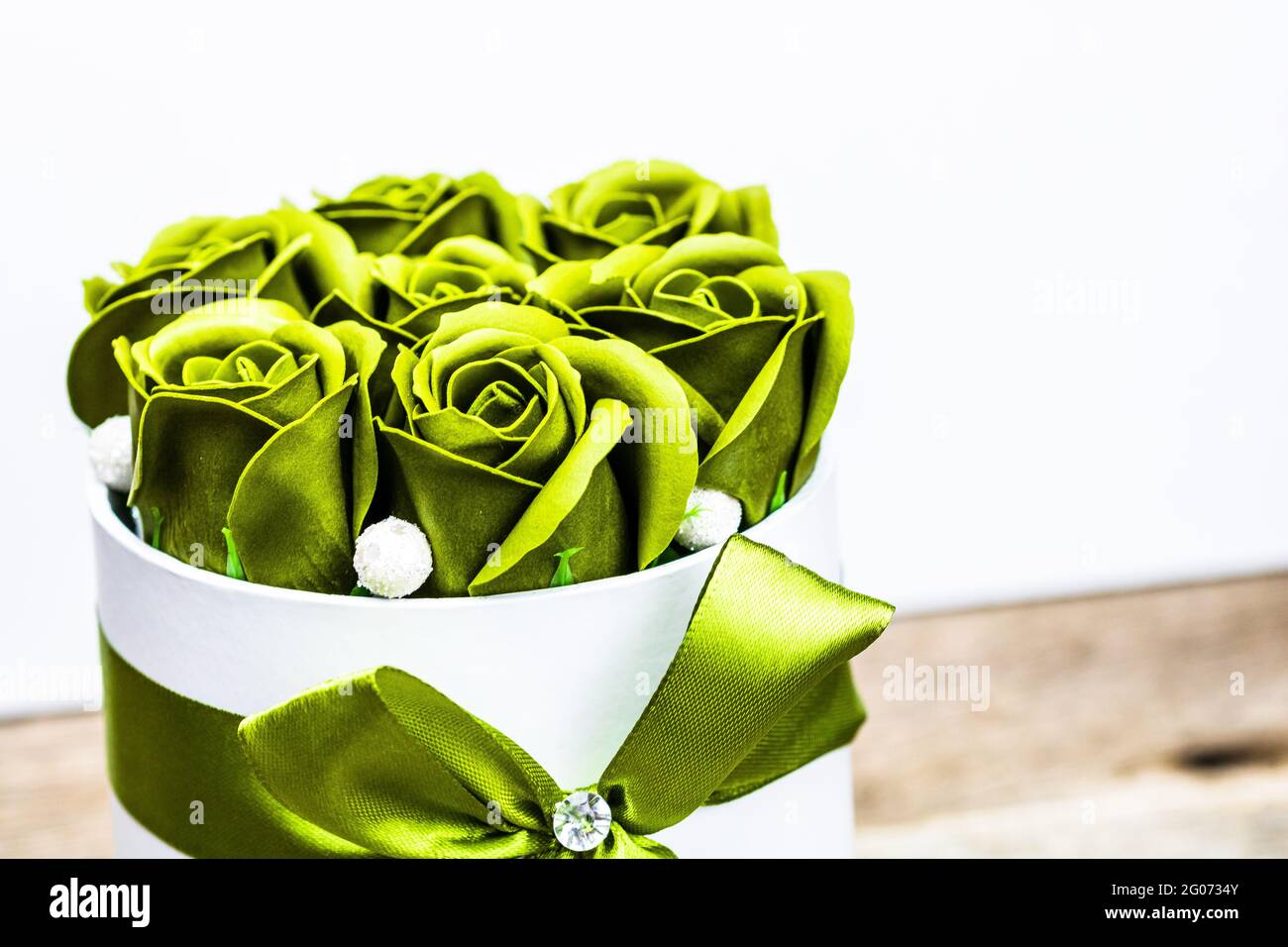 Green roses in a round luxury present box. Bouquet of flowers in a ...