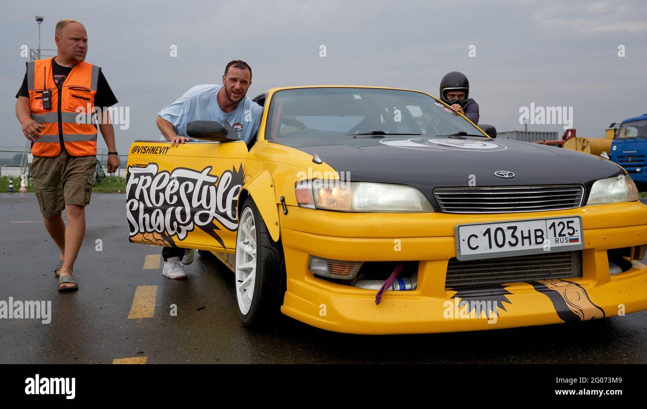 Participants evacuate a car from the track during the event.Festival ...