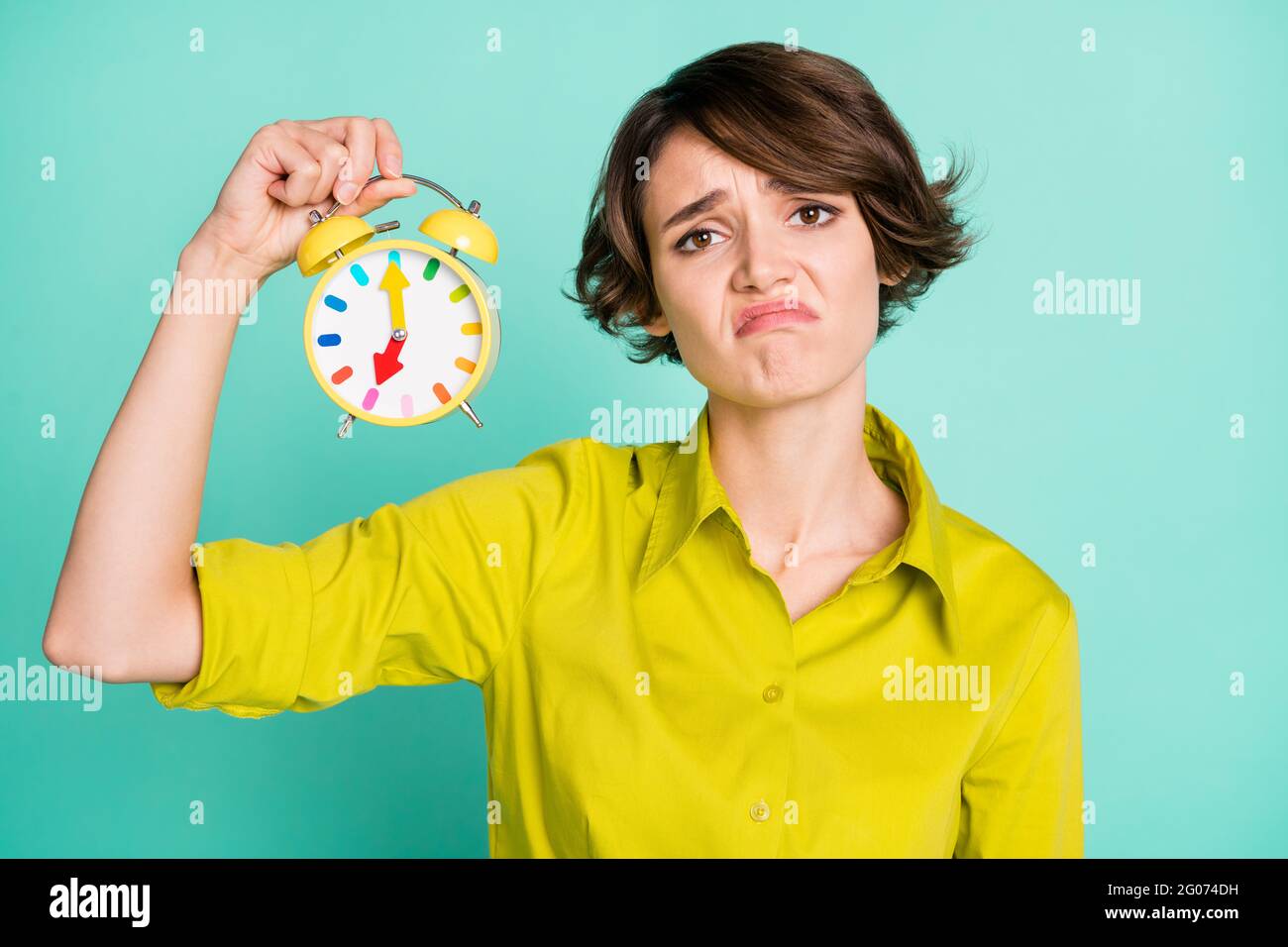 Photo portrait of grumpy female worker showing clock oversleep morning ...
