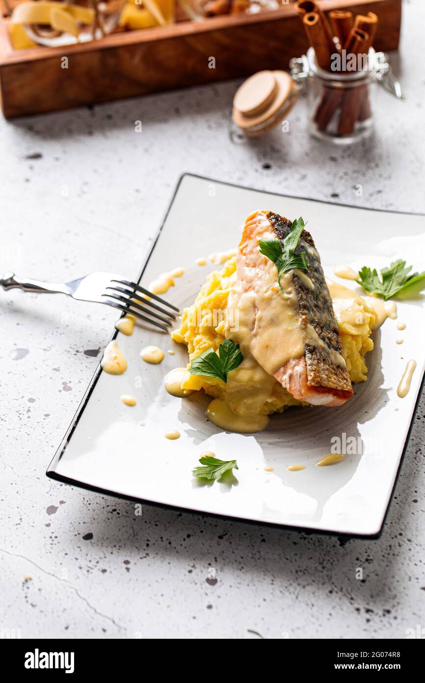 Salmon with mashed potatoes and sauce Stock Photo - Alamy