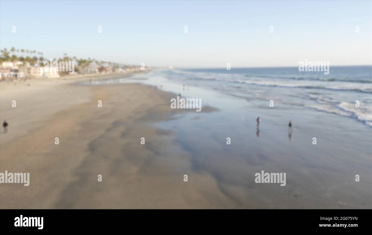 Defocused pacific ocean coast from pier. Sea water waves tide, shore ...