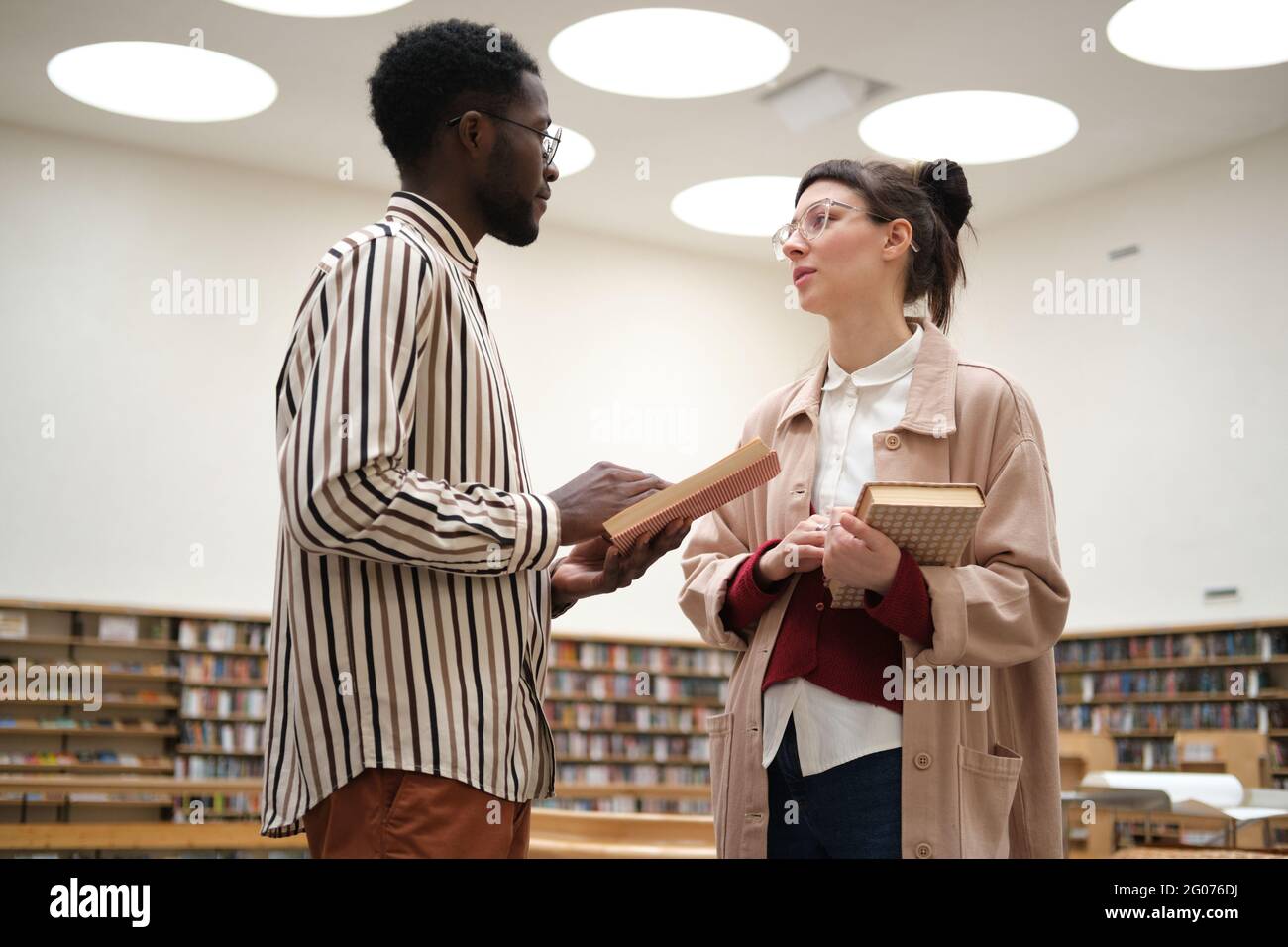 Two women discussing in library hi-res stock photography and images - Alamy