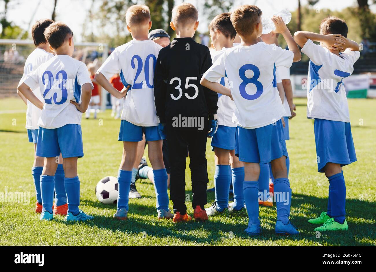 Happy Sporty Team With Coach on Half-Time Break. Children Football Team ...