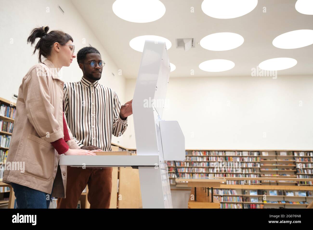 Couple standing on books hi-res stock photography and images - Alamy