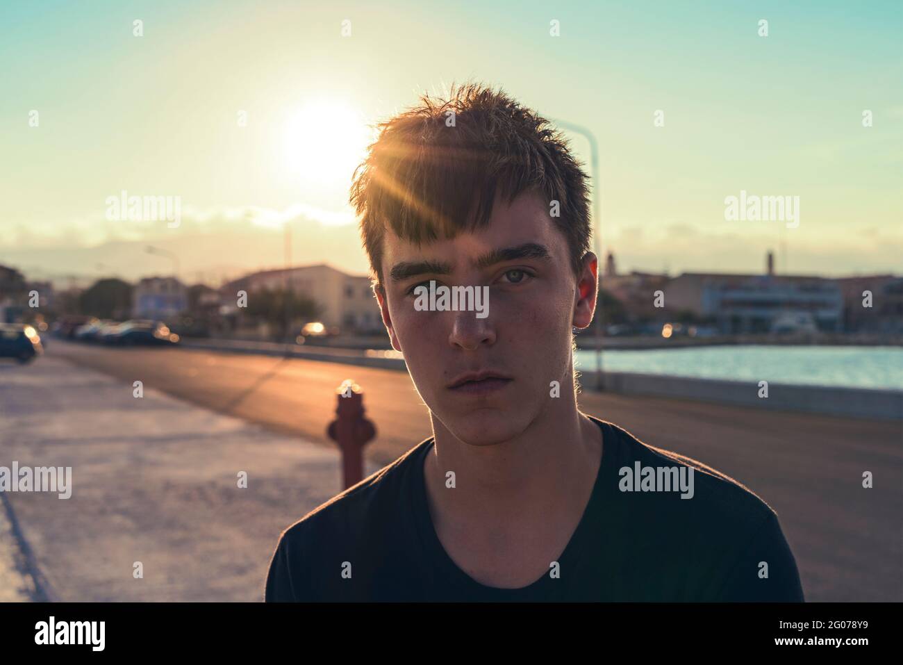 portrait of a serious teenager with the sun behind his head Stock Photo ...