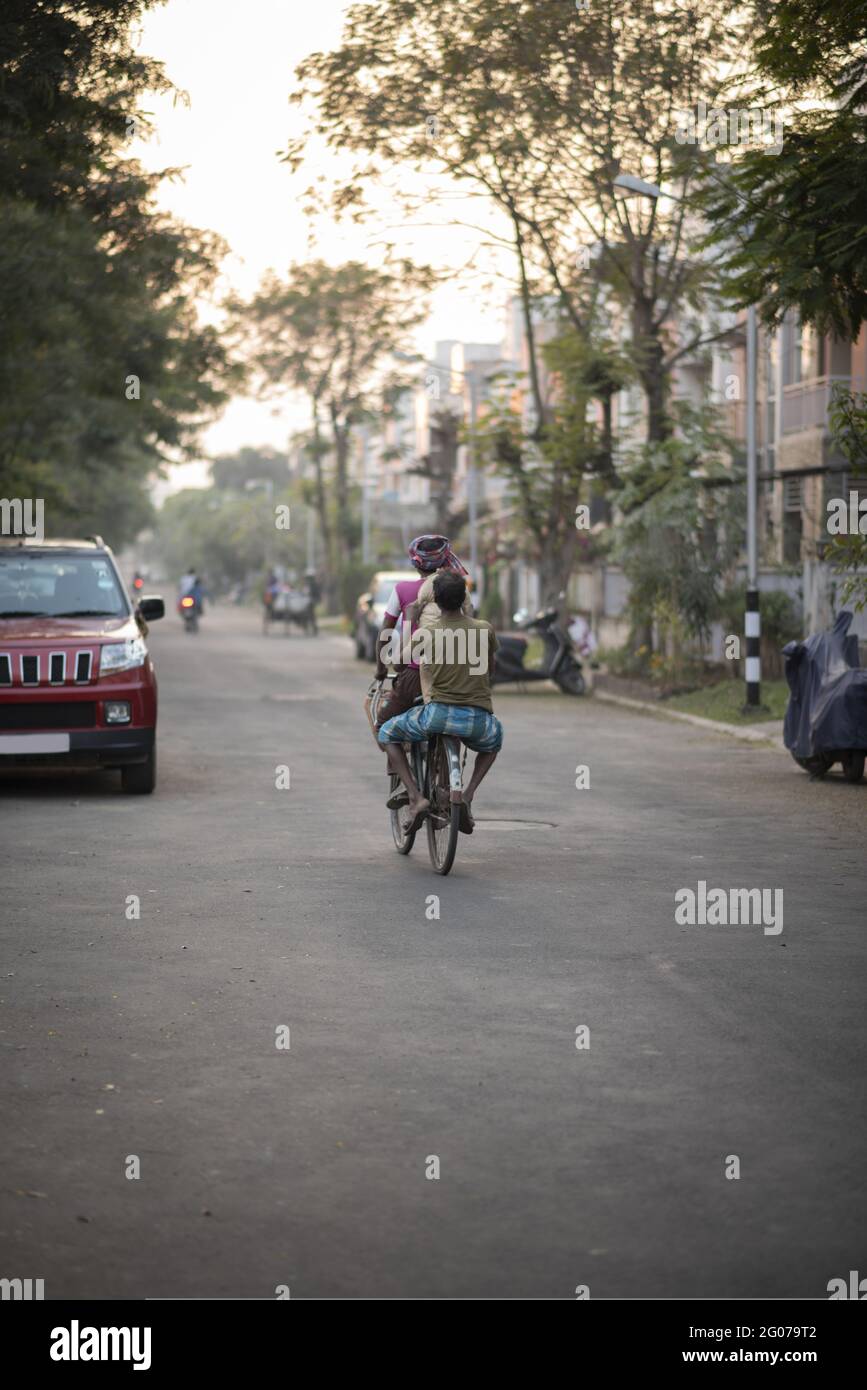 Vertical shot of people riding a bike together Stock Photo - Alamy