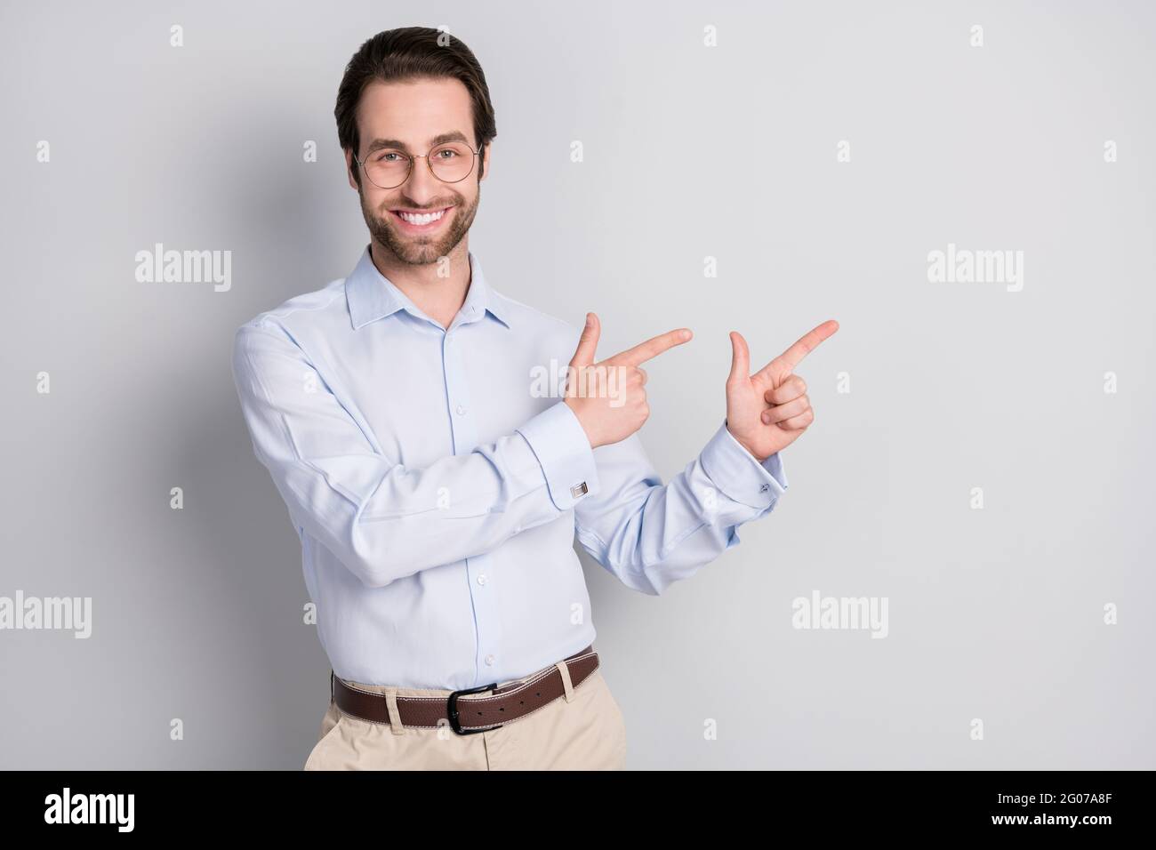 Portrait of attractive cheerful man expert agent broker demonstrating ...