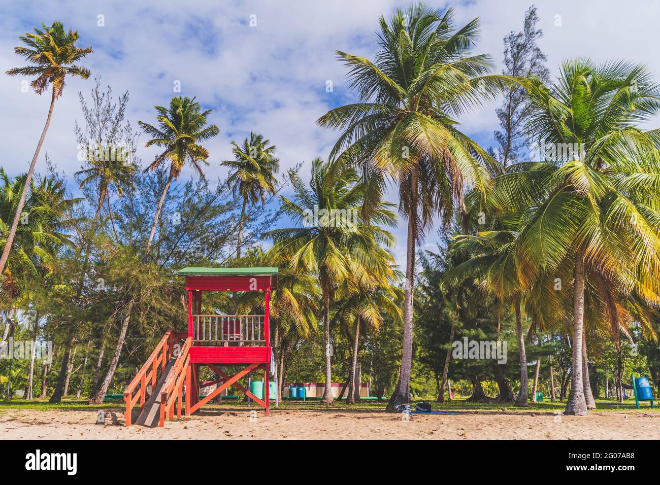 Red Life guard hut and palm trees on tropical beach. Luquillo Beach ...