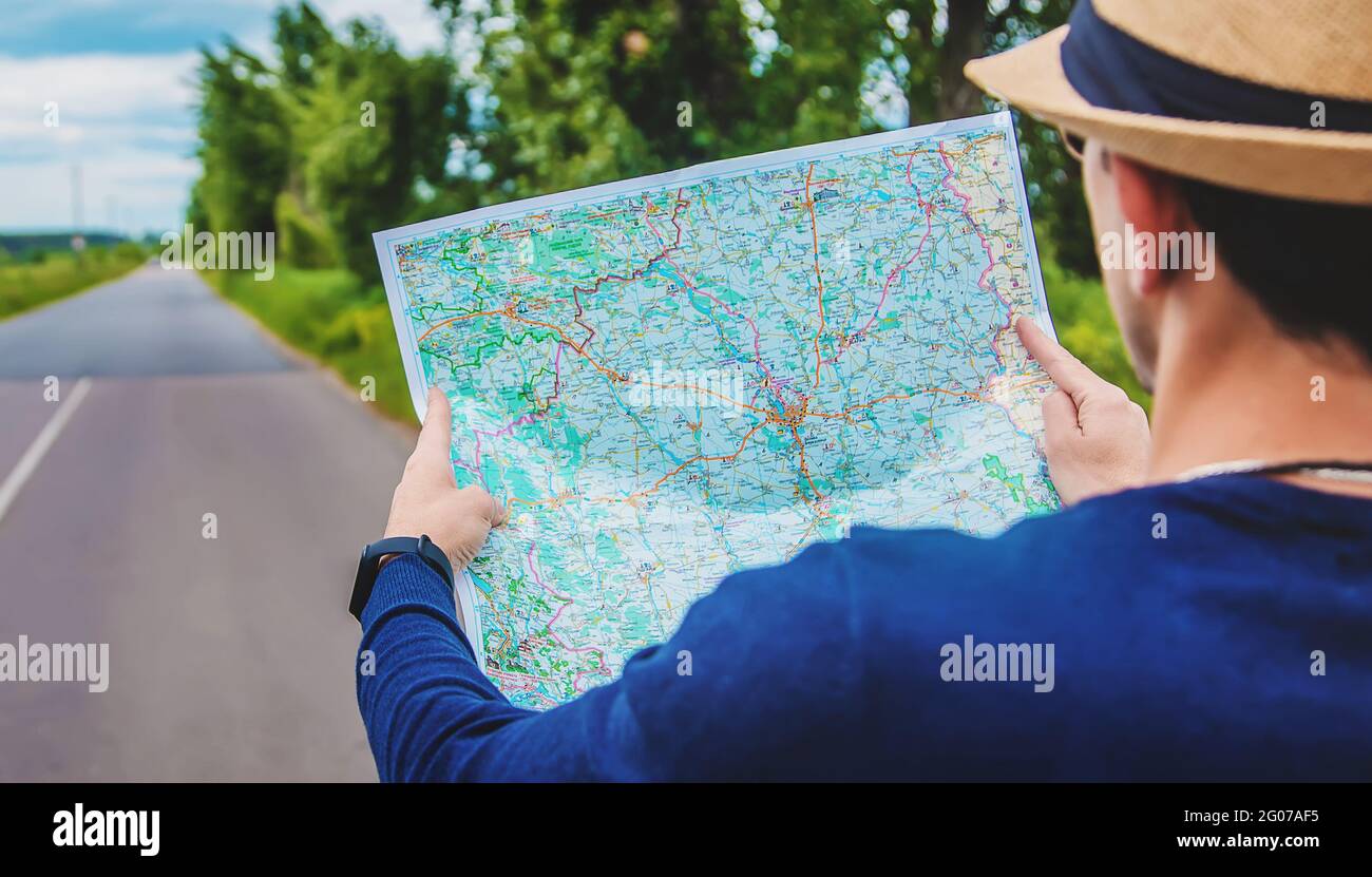 Man on road looks map hi-res stock photography and images - Alamy
