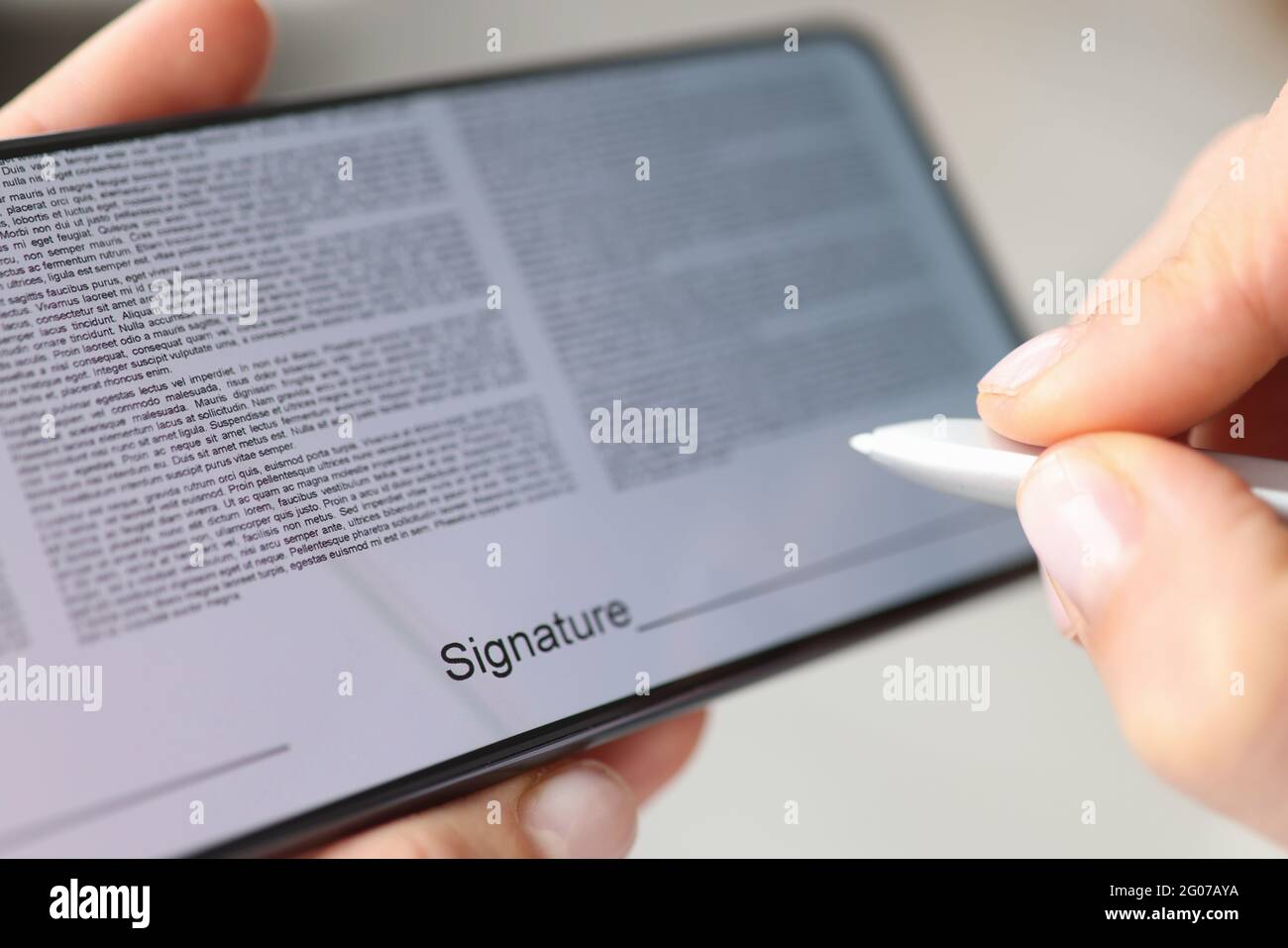 Person puts signature with stylus on contract screen of smartphone ...