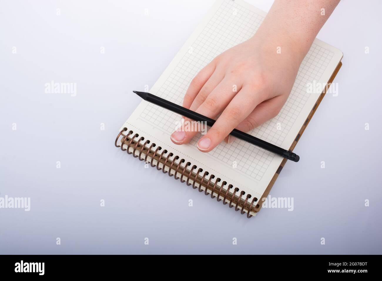 Human hand using pen to write down short note on notebook Stock Photo ...